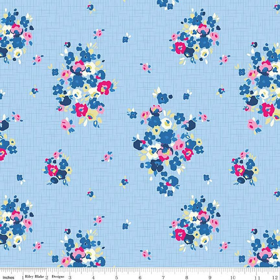 Blue Carolina knit fabric by Riley Blake features gorgeous flowers on blue